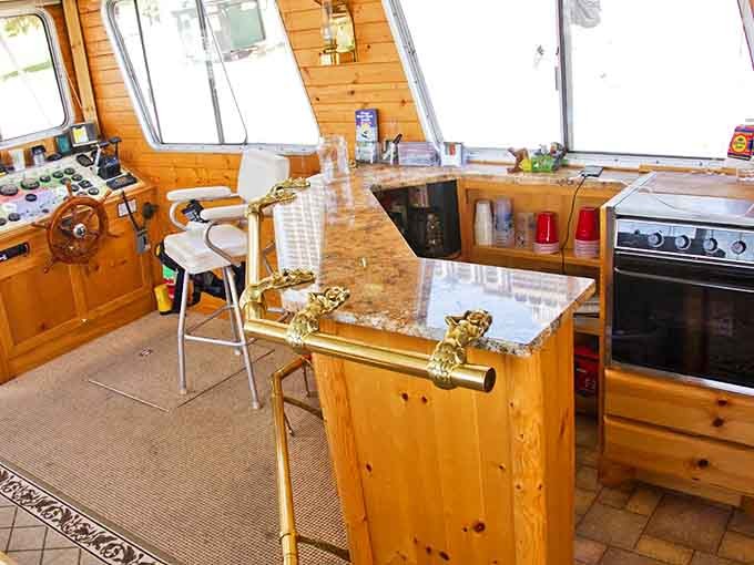 The well-appointed bar area features warm wood tones and a marble countertop, elevating the tiki experience beyond plastic cups.