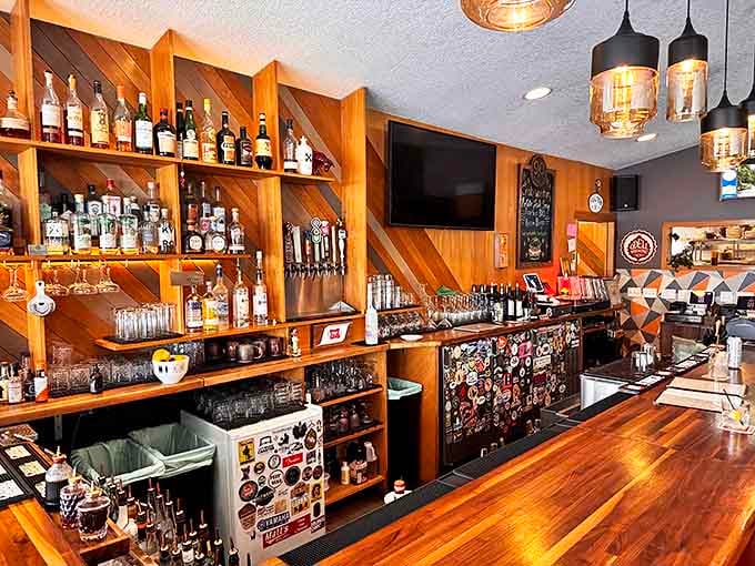 Spirits of the North! The meticulously crafted bar showcases an impressive selection of bottles against a backdrop of warm wooden shelving.