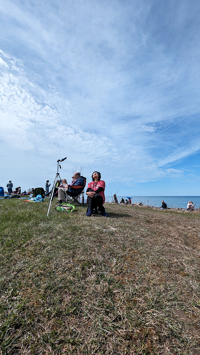 Beach enthusiasts stake their claim on prime viewing spots, settling in for a day of sunshine and spectacular lake views.