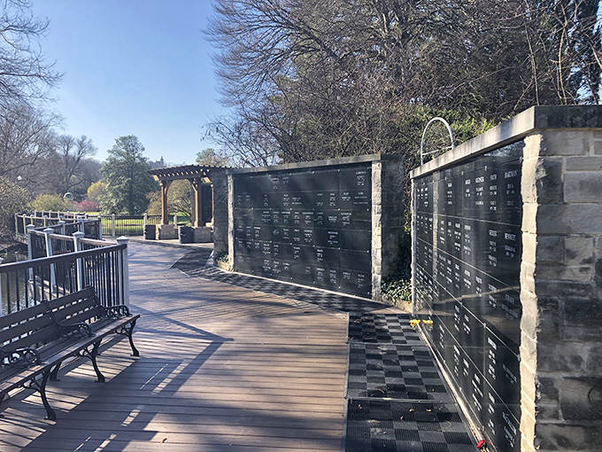Memorial plaques line this peaceful walkway, creating a contemplative space where visitors can reflect while enjoying nature.