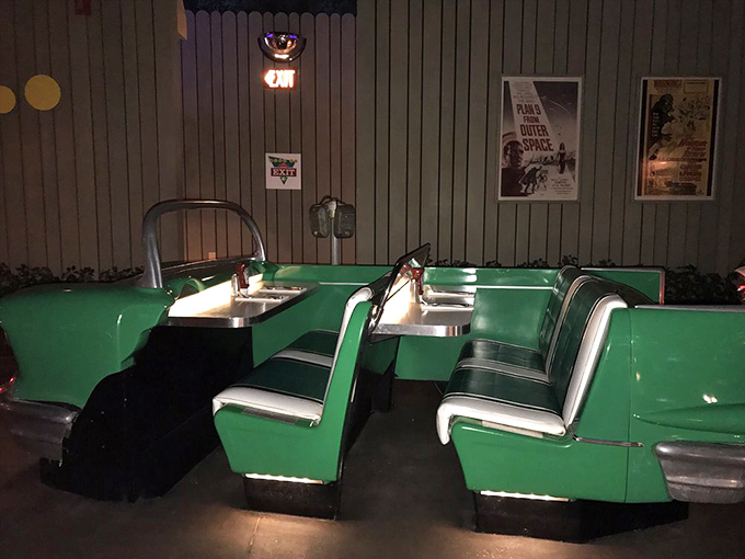Inside the green convertible booth, vintage movie posters set the scene while your table awaits, ready for whatever American classic you're ordering.