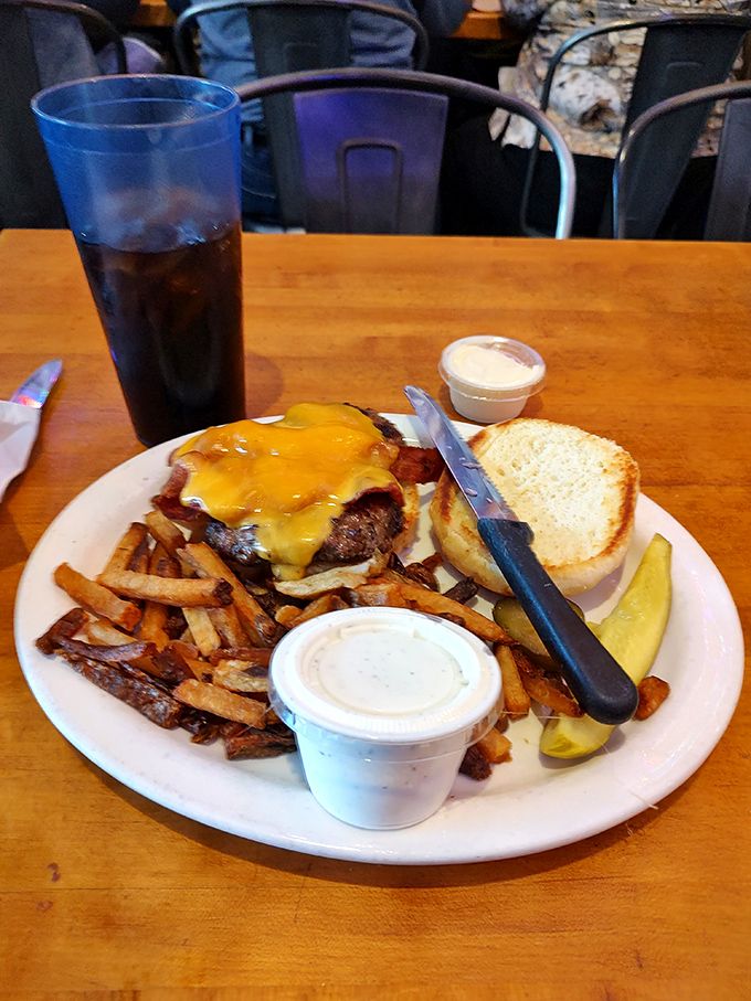 A perfectly cooked burger topped with melted cheese sits alongside golden hand-cut fries &ndash; comfort food elevated to an art form that satisfies on a primal level.