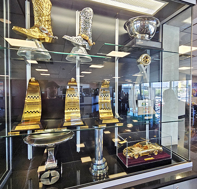 Trophy case treasures tell tales of champagne-soaked celebrations, with each gleaming cup representing countless hours of preparation and perfect execution.