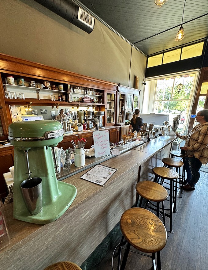Where milkshake magic happens &ndash; the counter with its vintage mixer stands ready to transform simple ingredients into legendary creations.
