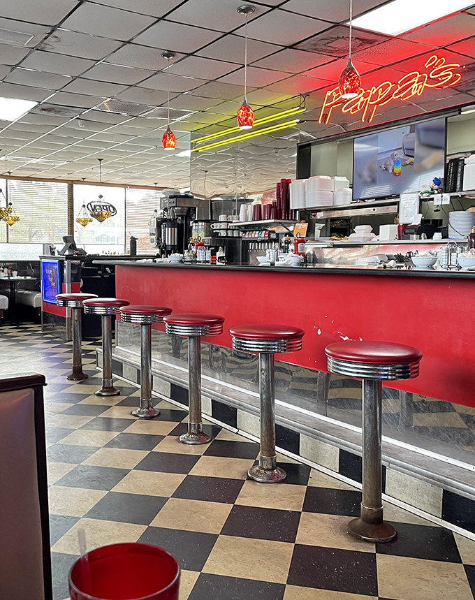 Classic counter seating where solo diners become temporary family. Those red stools have heard more life stories than most therapists.