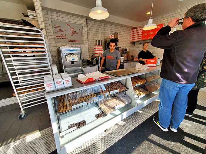 Customers patiently waiting for their turn at doughnut nirvana, each one knowing that some pleasures are absolutely worth the wait.