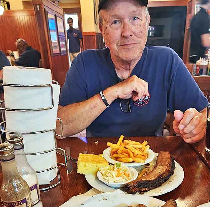 A patron enjoying the fruits of low-and-slow labor &ndash; the kind of meal that requires strategic planning and an empty schedule afterward.