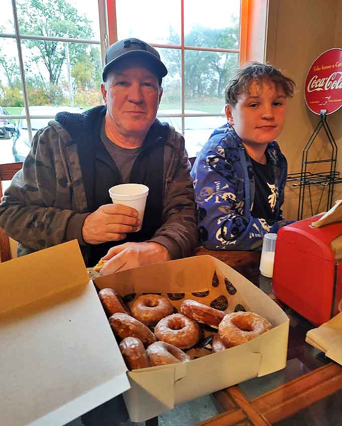 Happy customers enjoying the fruits of Station 66's labor &ndash; where boxes of donuts bring joy and create memories that last long after the last crumb disappears.