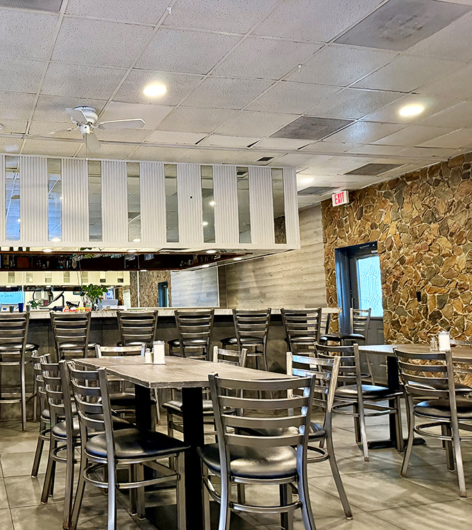 Modern meets classic in this dining area where stone walls and contemporary seating create an unexpected twist on diner aesthetics.