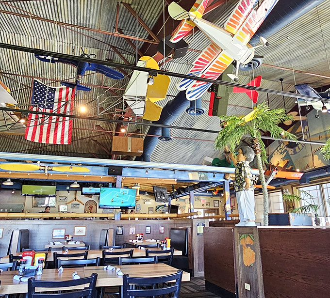 Model planes suspended from industrial ceilings create a three-dimensional timeline of aviation history right above your meatloaf.