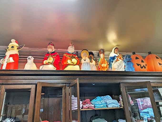 Halloween blow molds stand sentinel above vintage clothing, like plastic guardians of holidays past waiting to light up new memories.