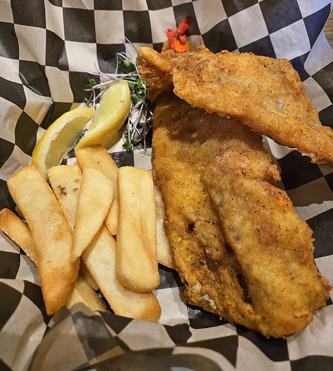 Golden-fried fish nestled alongside hand-cut fries &ndash; simple food done right, where the crunch gives way to flaky perfection that needs nothing more than a squeeze of lemon.