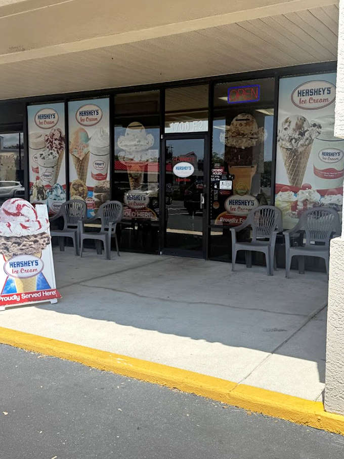 The storefront invites you in with giant ice cream images and an "OPEN" sign that might as well read "happiness available now, come on in already."