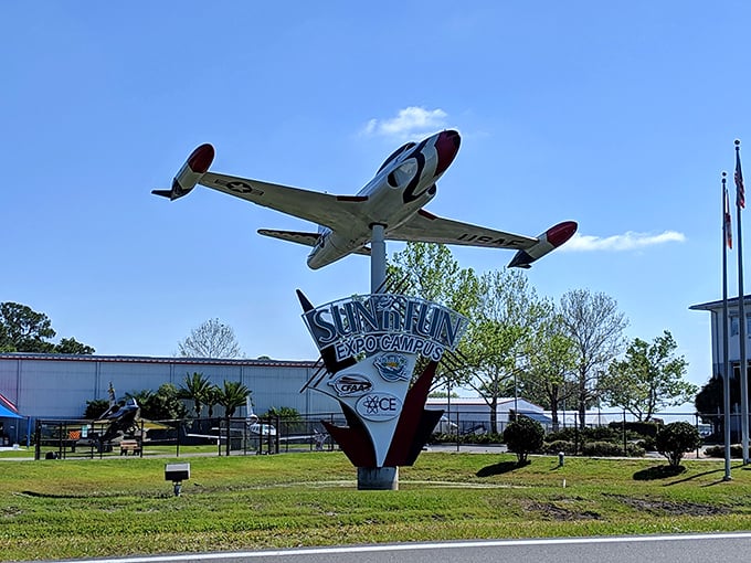 The Sun 'n Fun Expo Campus sign welcomes aviation enthusiasts with a perfectly positioned aircraft overhead. It's like the Statue of Liberty for pilots and plane lovers.