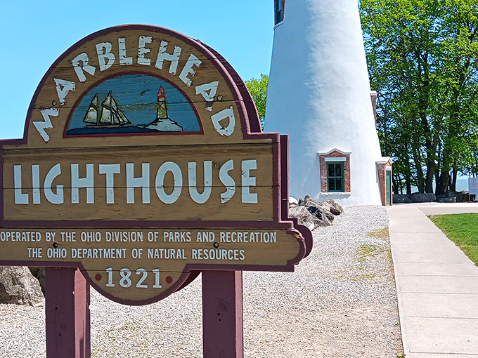 The vintage wooden sign proudly proclaims the lighthouse's 1821 heritage – a testament to craftsmanship that has withstood two centuries of Lake Erie weather.