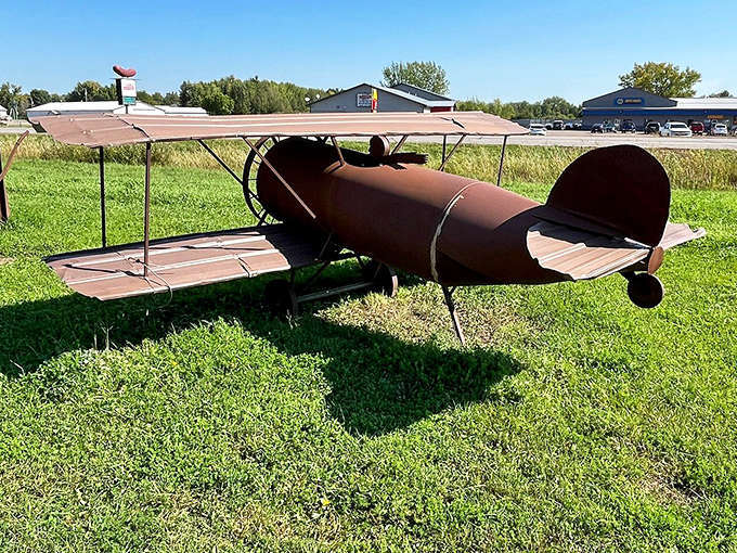 This rusty biplane will never achieve flight, but it soars in artistic ambition &ndash; a grounded tribute to aviation dreams amid Minnesota's prairie grasses.