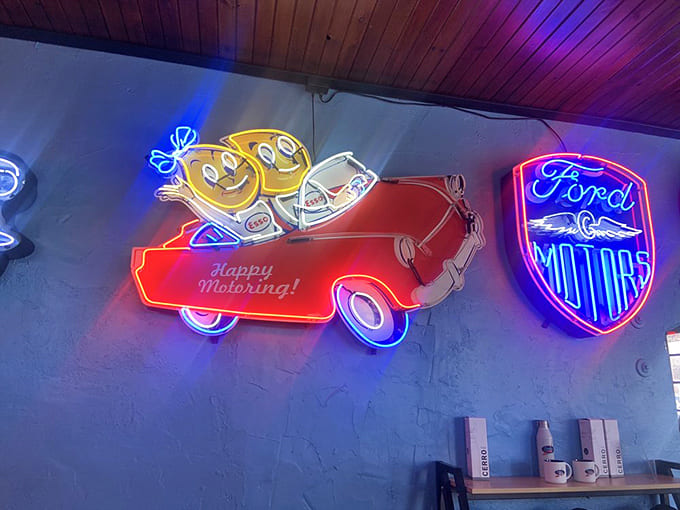 "Happy Motoring!" indeed&mdash;these glowing vintage signs don't just illuminate the space, they transport you to an era when service stations had personality.