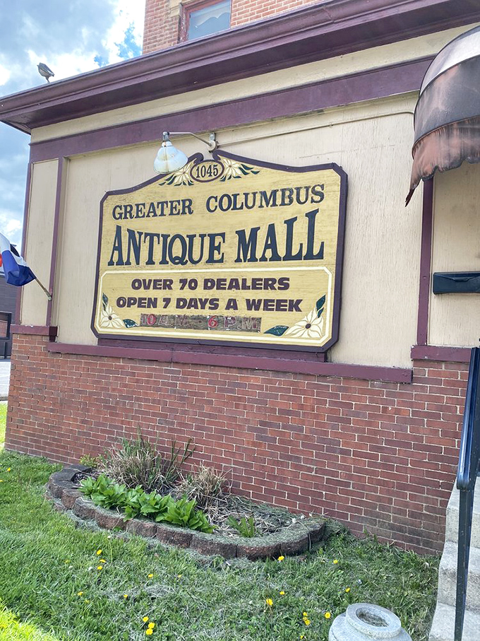 The iconic yellow sign against weathered brick serves as a beacon for treasure hunters, standing out against the historic architecture of the building.