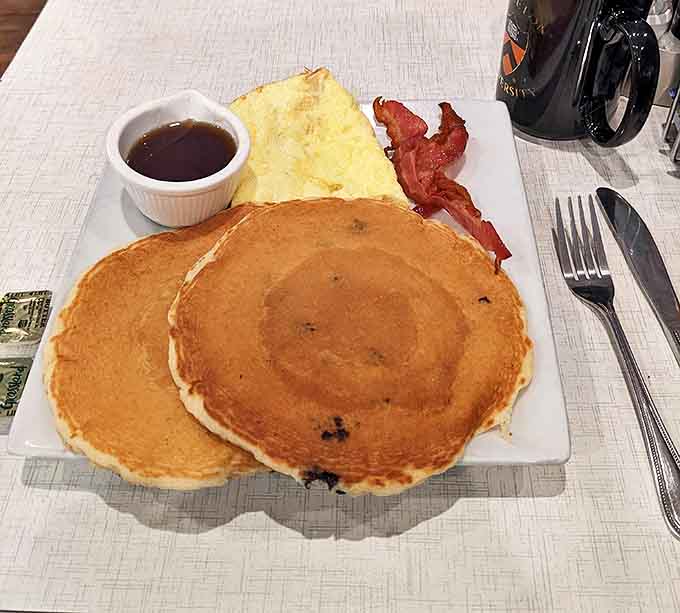 Pancakes so fluffy they practically float off the plate, paired with crispy bacon because balance in all things is important.