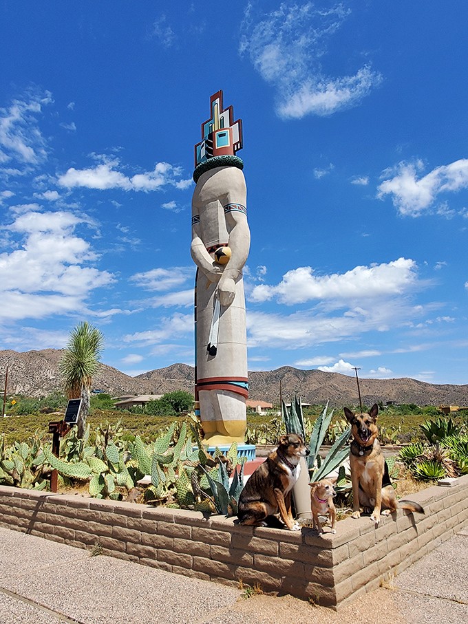 Four-legged visitors seem equally impressed by the towering figure that dominates the desert landscape.