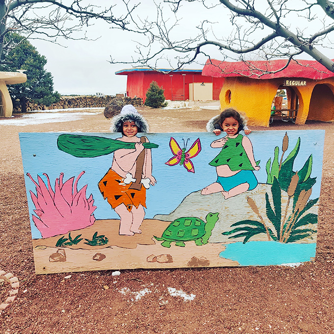 A delightful photo board invites visitors to become honorary Stone Age citizens, complete with palm trees and prehistoric fashion.
