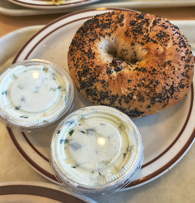 This poppy seed bagel with cream cheese isn't trying to reinvent breakfast &ndash; it's too busy being perfectly, simply delicious.