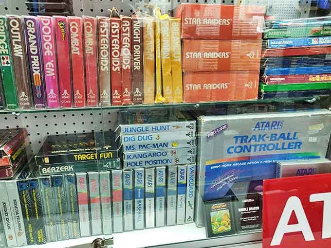 The Atari collection gleams under display lights, those iconic cartridges representing gaming's pioneering days when pixels were few but imagination was boundless.