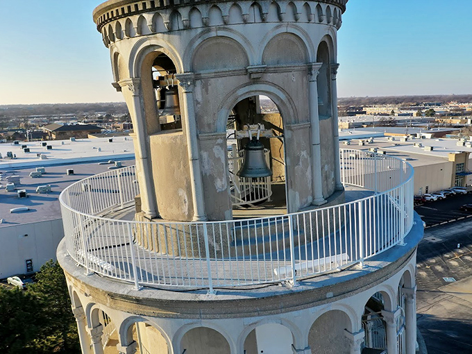 From the top, the bell chamber offers a crowning touch to the structure, complete with a railing and colorful flags fluttering in the breeze.