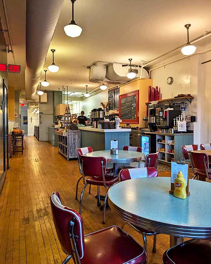 Retro tables, classic red chairs, and warm lighting create the kind of cozy atmosphere where conversations flow easily and coffee never seems to cool too quickly.
