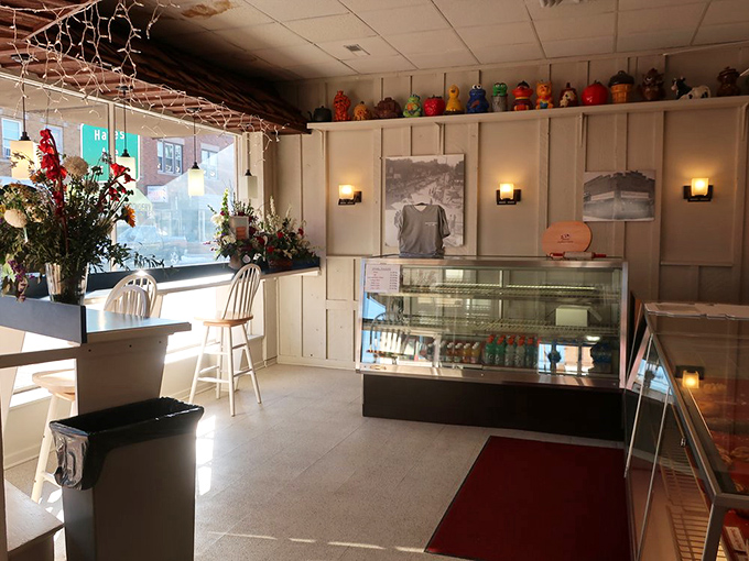 Inside the bakery, a cozy atmosphere invites customers to linger, filled with the comforting aroma of fresh pastries and the friendly bustle of longtime patrons savoring their favorites.