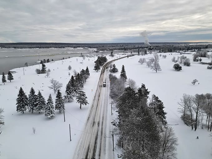 Winter transforms the waterfront into a frozen landscape where snow blankets everything, proving that Upper Peninsula residents are tougher than the rest of us mere mortals.