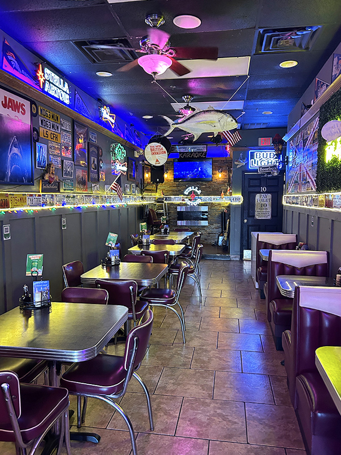 Cozy booths and retro chairs invite lingering conversations under the glow of neon and the watchful eye of a ceiling-mounted shark.