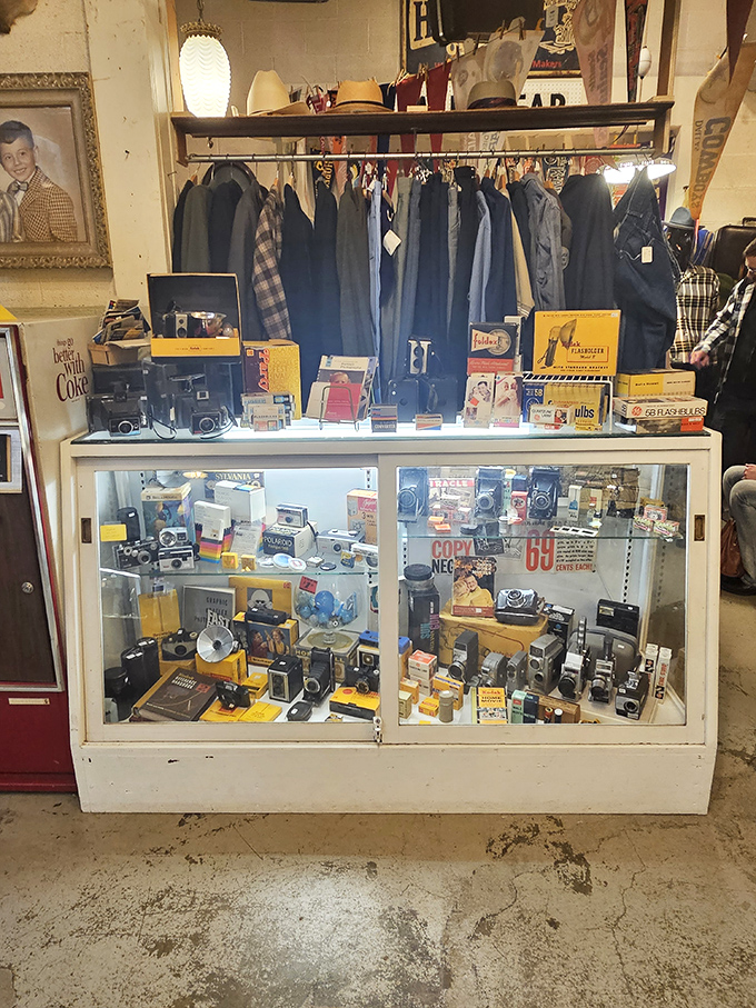 Vintage cameras and men's fashion share space in this display, capturing the essence of an era when style was mandatory, not optional.