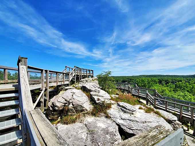 The wooden walkway and observation deck blend harmoniously with the rugged landscape, human engineering complementing nature's grand design.