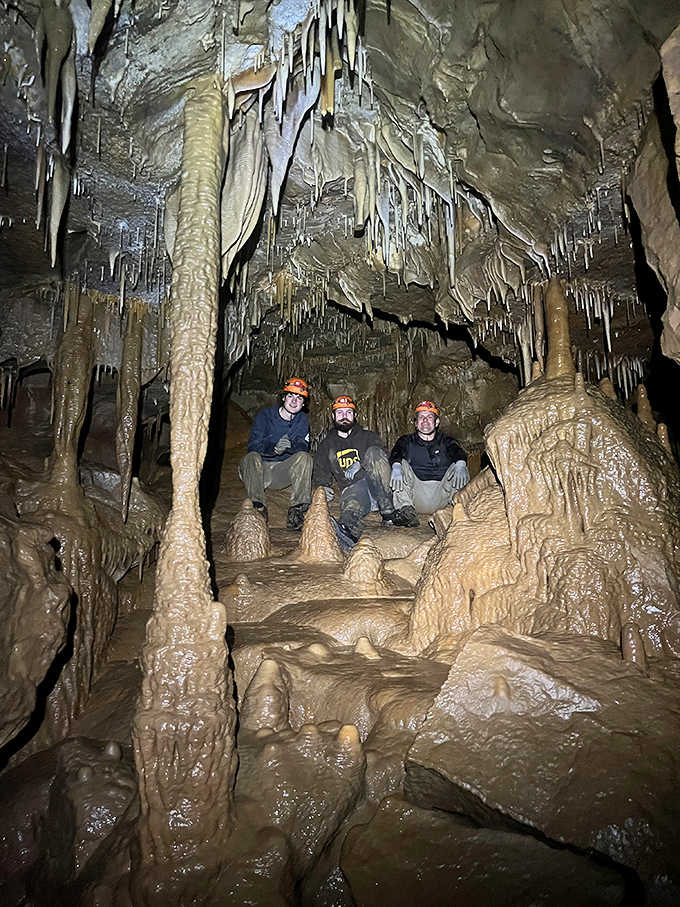 Cavers take a moment to appreciate their surroundings, dwarfed by formations that began growing when mammoths still roamed Ohio.