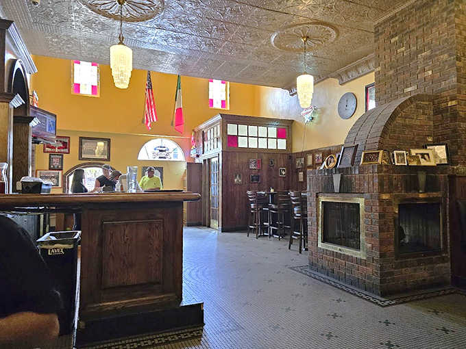 The restaurant's classic interior features ornate tin ceilings, warm yellow walls, and architectural details that transport diners to another era entirely.