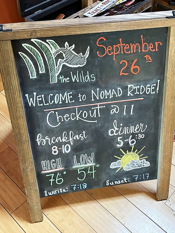 The daily chalkboard welcomes visitors with weather forecasts and meal times, creating the comfortable routine that makes The Wilds feel like home.