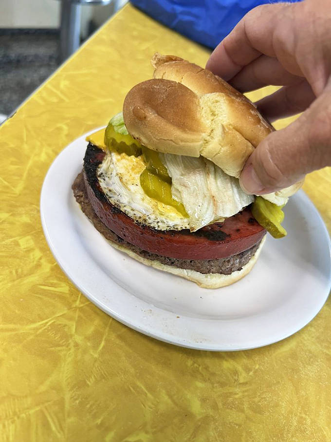 The barnyard burger featuring a sunny-side-up egg that winks at you from atop its beefy throne.