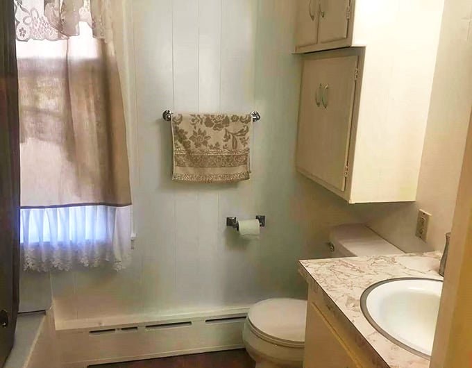 Clean lines and simple fixtures prove that historical accommodations don't have to mean sacrificing modern bathroom comforts.