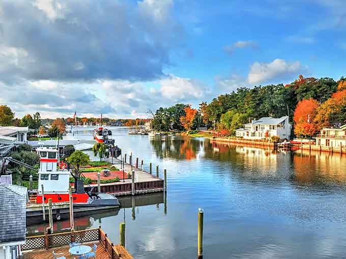 Enjoy a peaceful day by the water, where colorful fall trees and friendly boats create a picture-perfect lakeside retreat.