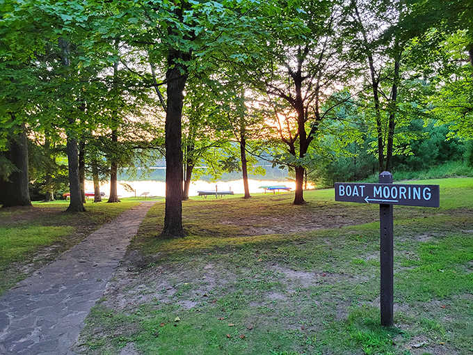The boat mooring area welcomes water enthusiasts, with the golden hour light turning even the simplest sign into something magical.