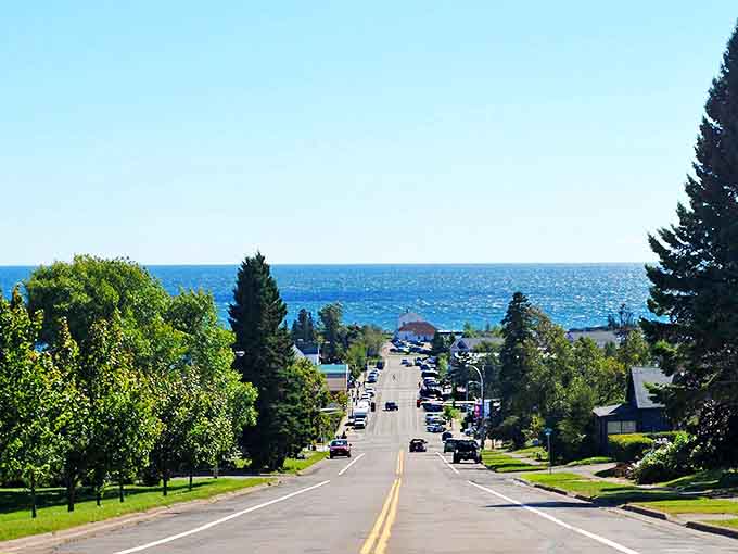 Broadway Avenue slopes gently toward Lake Superior, creating the kind of perfect small-town vista that makes visitors contemplate real estate listings.