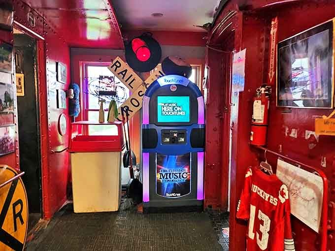 The vintage jukebox stands ready to provide the soundtrack for your meal, surrounded by railroad memorabilia and sports treasures.