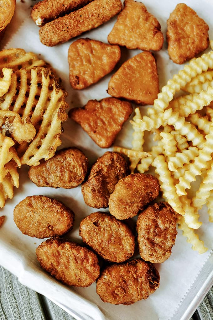 Crispy, bite-sized morsels nestled among waffle fries &ndash; comfort food geometry at its finest, no fancy dipping sauces required.