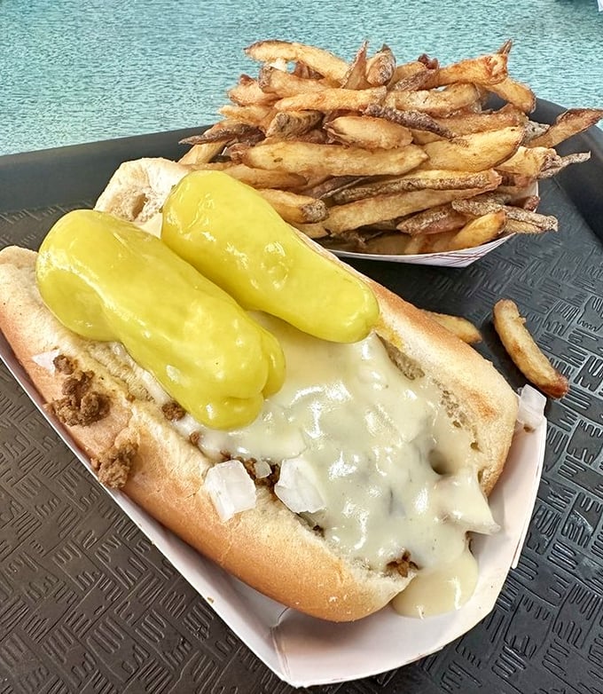 A classic chili cheese dog nestled beside hand-cut fries proves that sometimes the messiest foods deliver the most satisfying flavors.