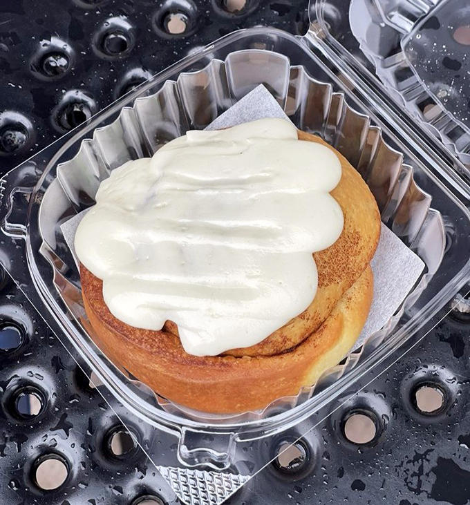 A cinnamon roll that deserves its own fan club. That cream cheese frosting melting into warm spirals of cinnamon-sugar perfection is pure edible poetry.