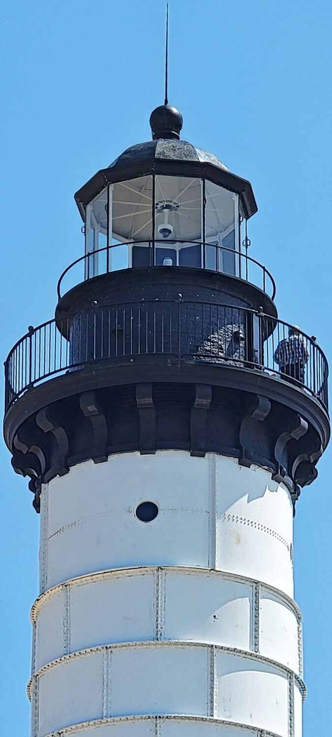 The lighthouse's lantern room and gallery showcase the engineering brilliance of 19th-century lighthouse construction, still standing strong against Lake Michigan's moods.