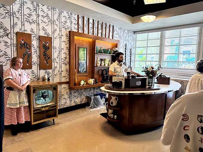 The counter area showcases period-perfect details, from the vintage cash register to the uniformed staff ready to serve with a smile.