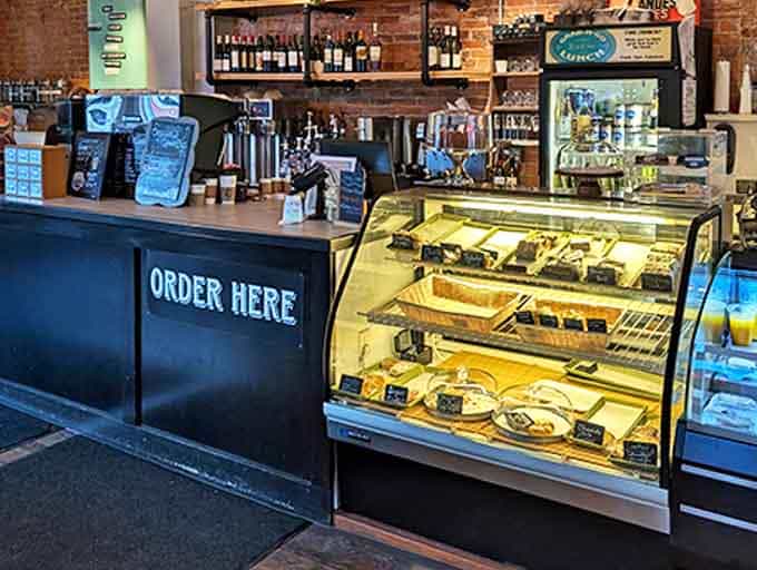 The counter serves as command central, where pastries tempt from behind glass while baristas orchestrate caffeinated magic.