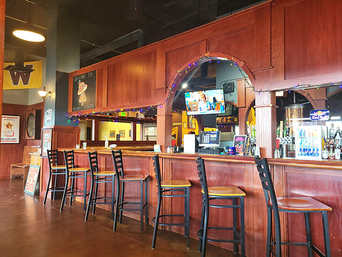 Counter seating with wooden arches overhead gives solo diners and couples a front-row view of the pizza-making magic.
